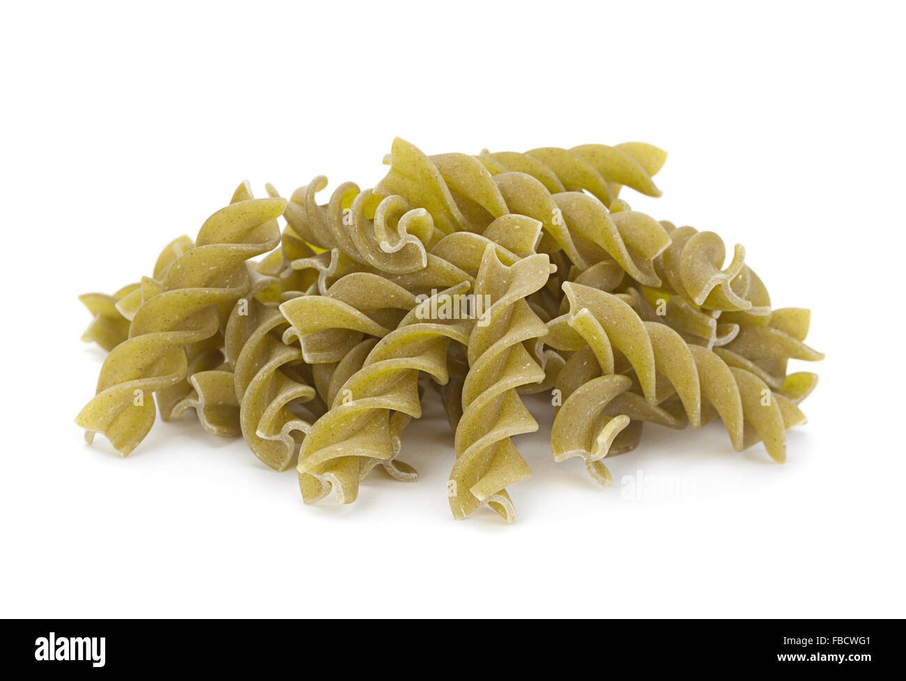 Green swirl dry pasta closeup isolated on white background Stock Photo ...