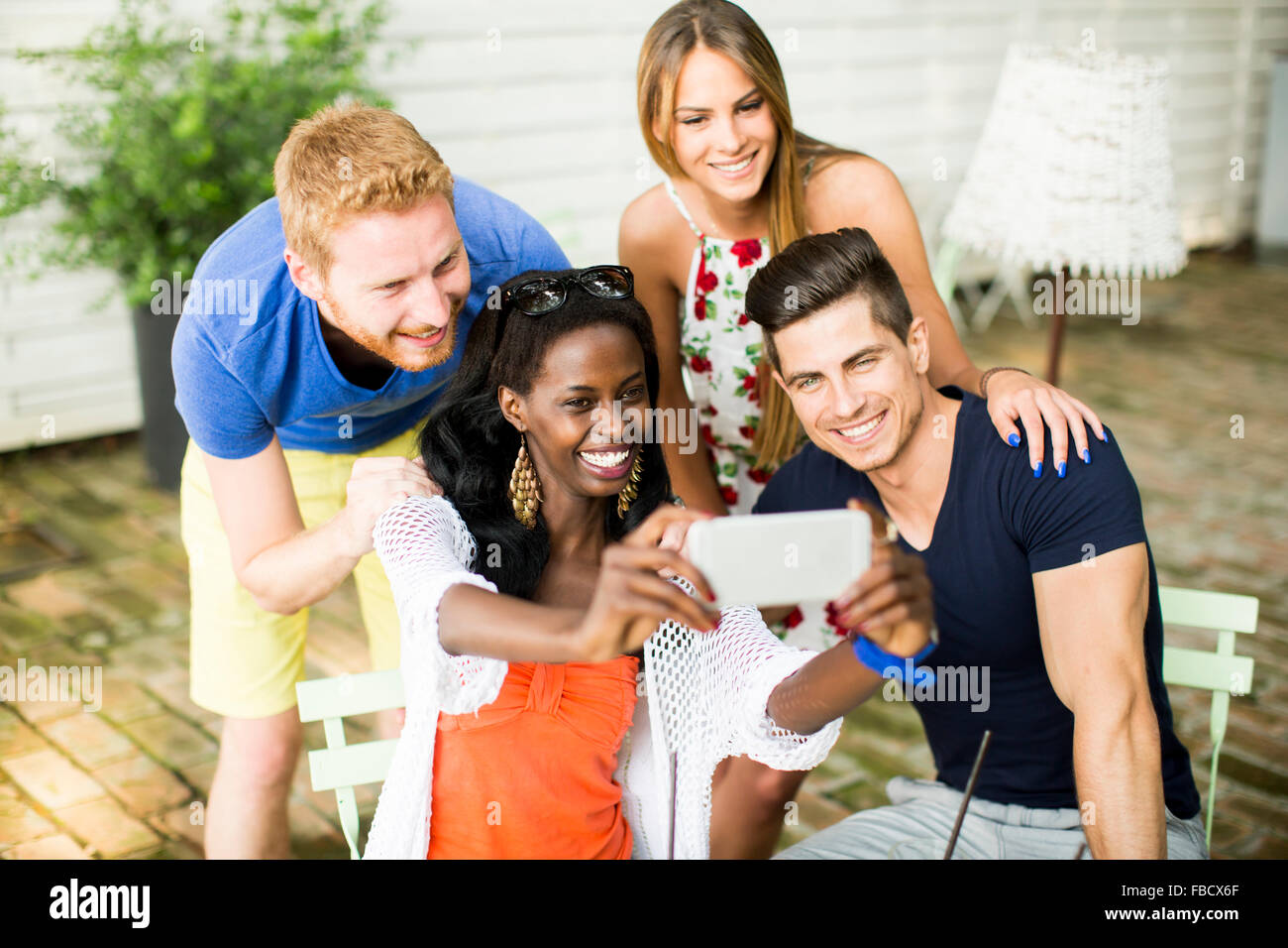 Young multiracial friends at cafe Stock Photo - Alamy