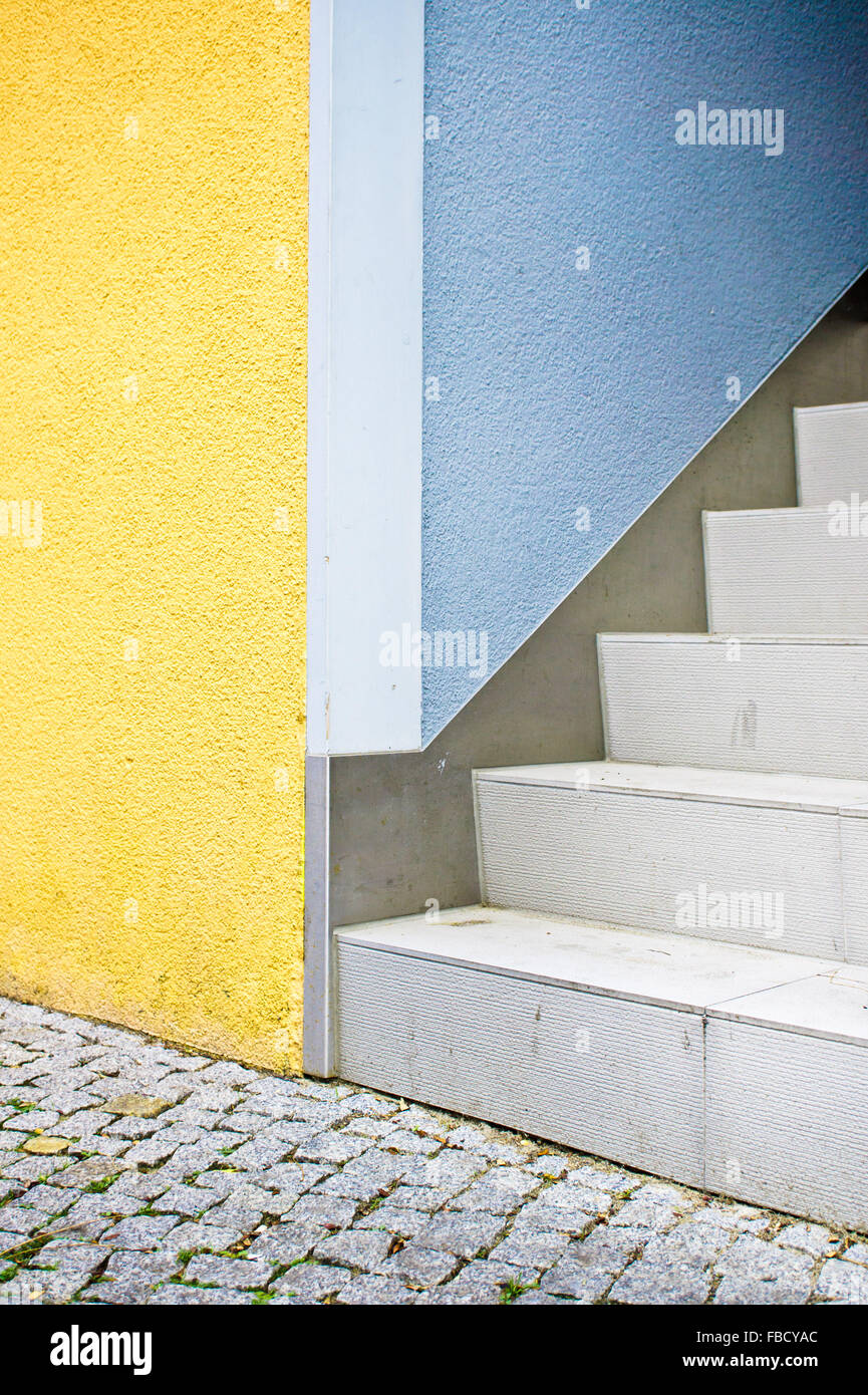 Stone steps next to a colourful wall Stock Photo - Alamy