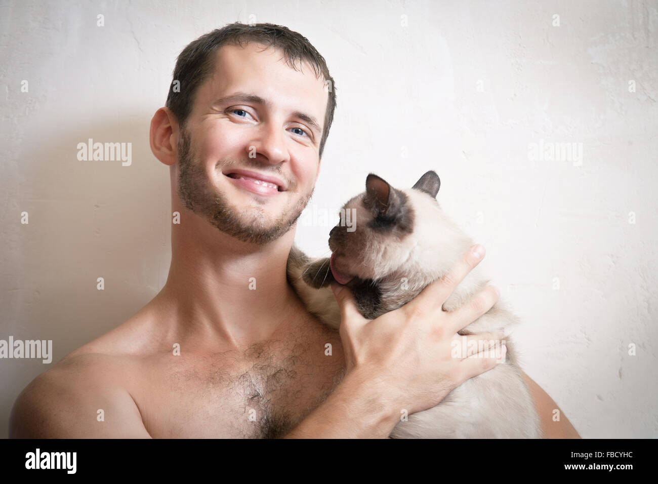 Portrait of a young attractive man with his cat Stock Photo - Alamy