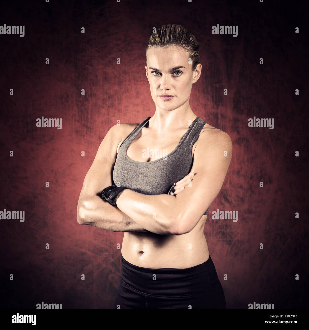 Composite image of muscular woman with arms crossed Stock Photo - Alamy