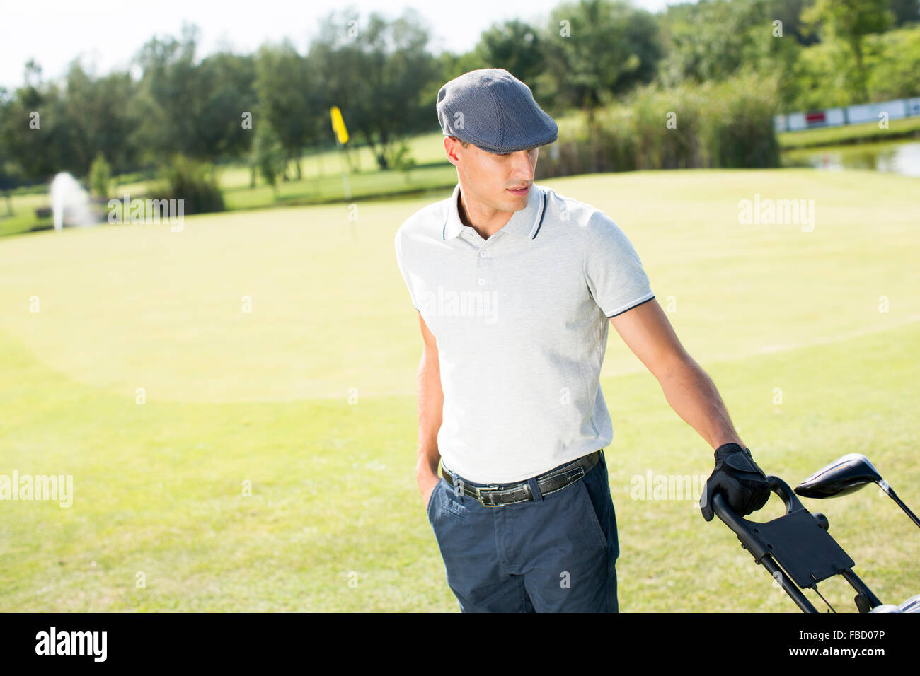 Young man playing golf Stock Photo - Alamy
