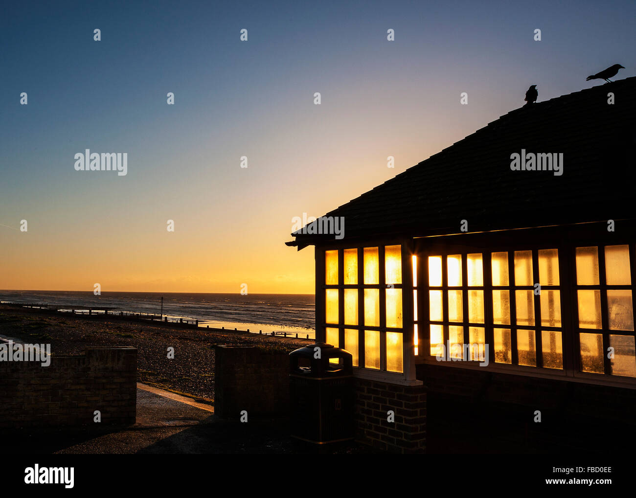 Sunrise through glass windows of beach shelter Stock Photo - Alamy