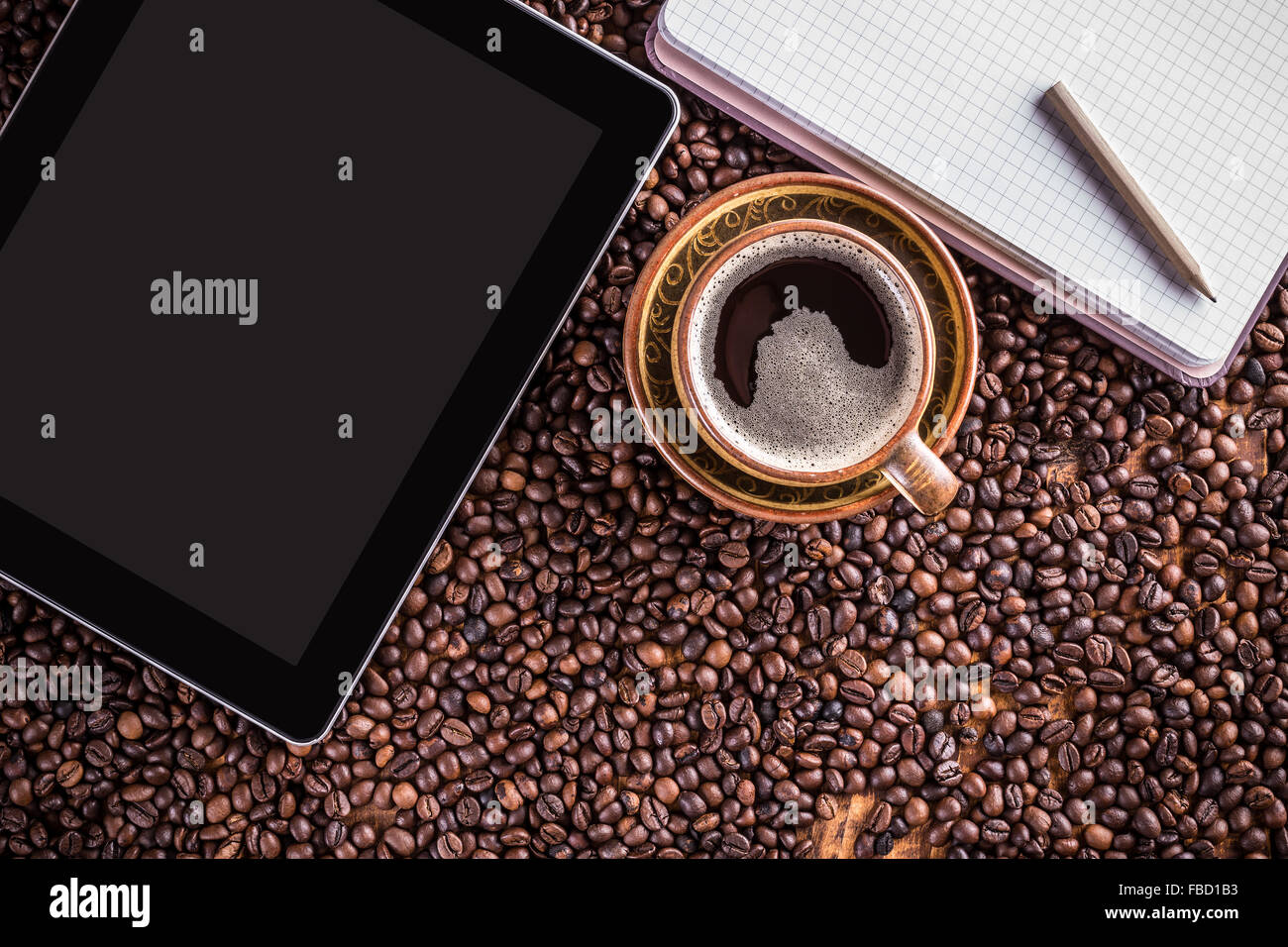 Digital tablet, note paper and coffee cup on coffee beans background ...