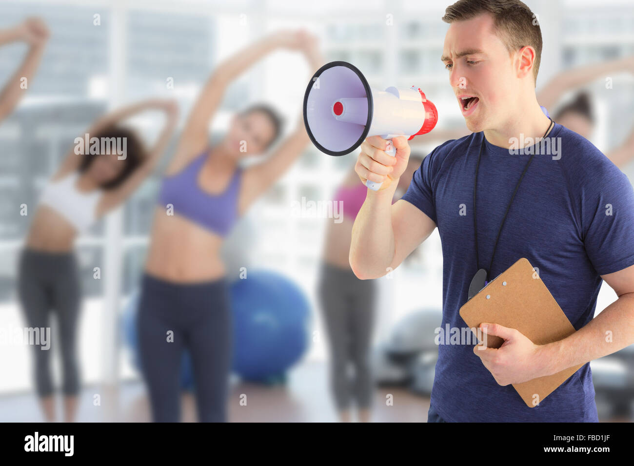 Composite image of male trainer yelling through the megaphone Stock ...
