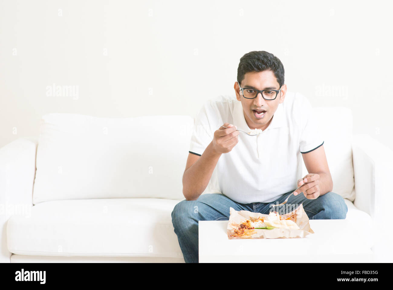 Indian man eating home hi-res stock photography and images - Alamy