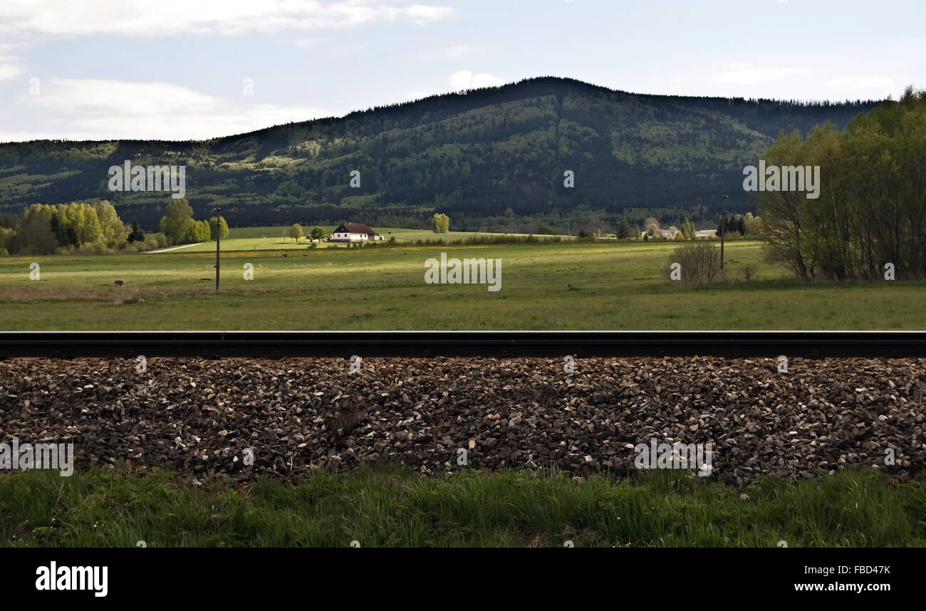 railway train, meadow with isolated houses and Smrcina (Hochficht) hill ...