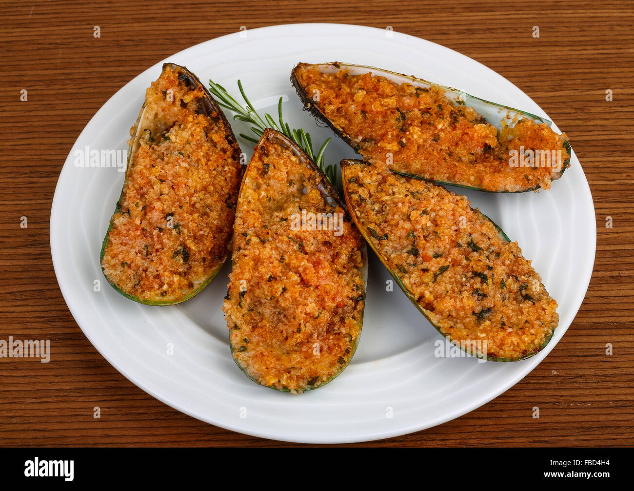Baked mussels with bread and spices served rosemary Stock Photo - Alamy