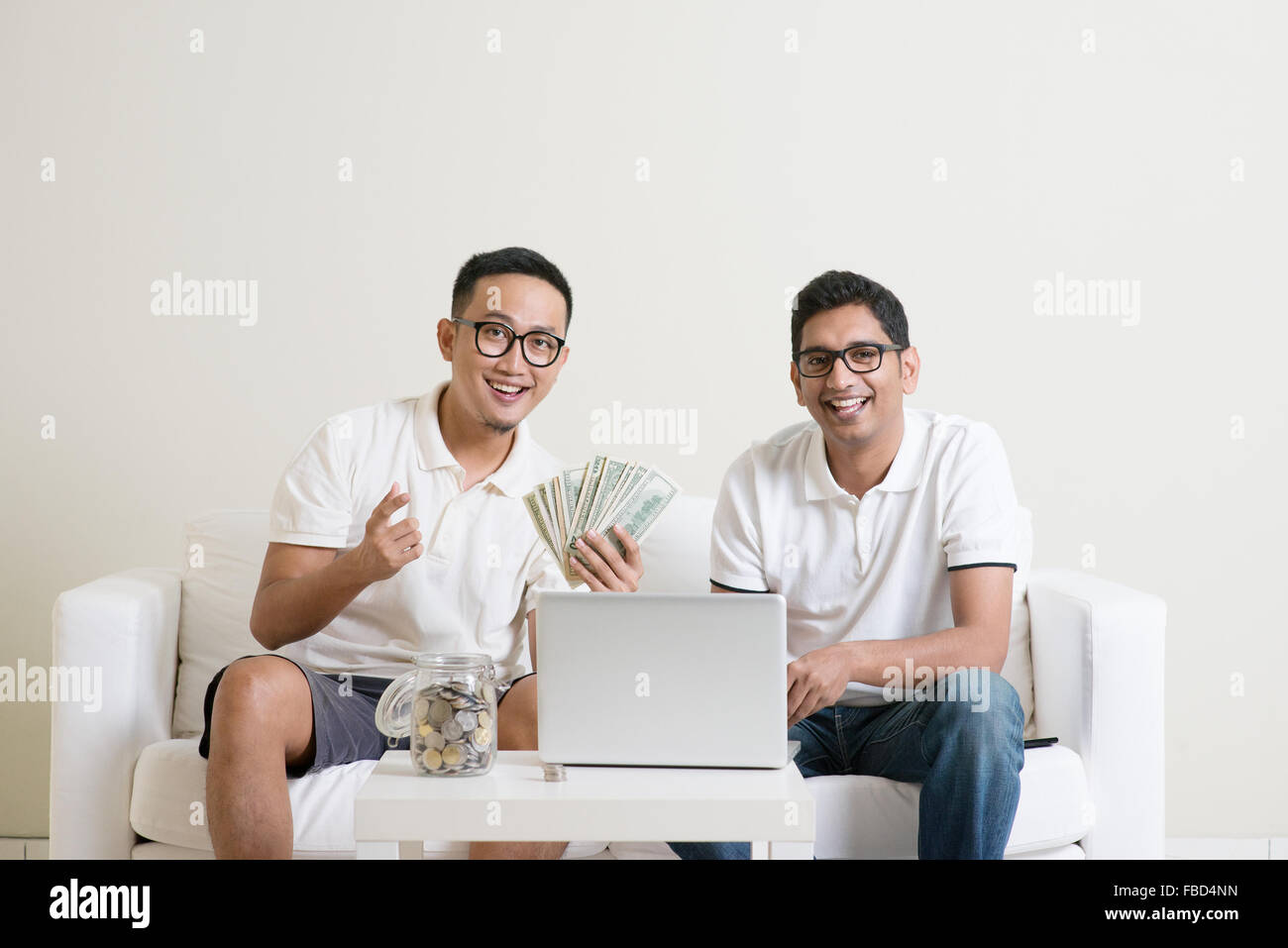 eBusiness concept. Young guys counting cash with partner, earning money ...