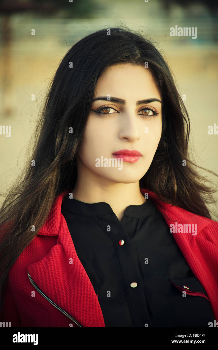 Serious young woman staring outdoors Stock Photo - Alamy