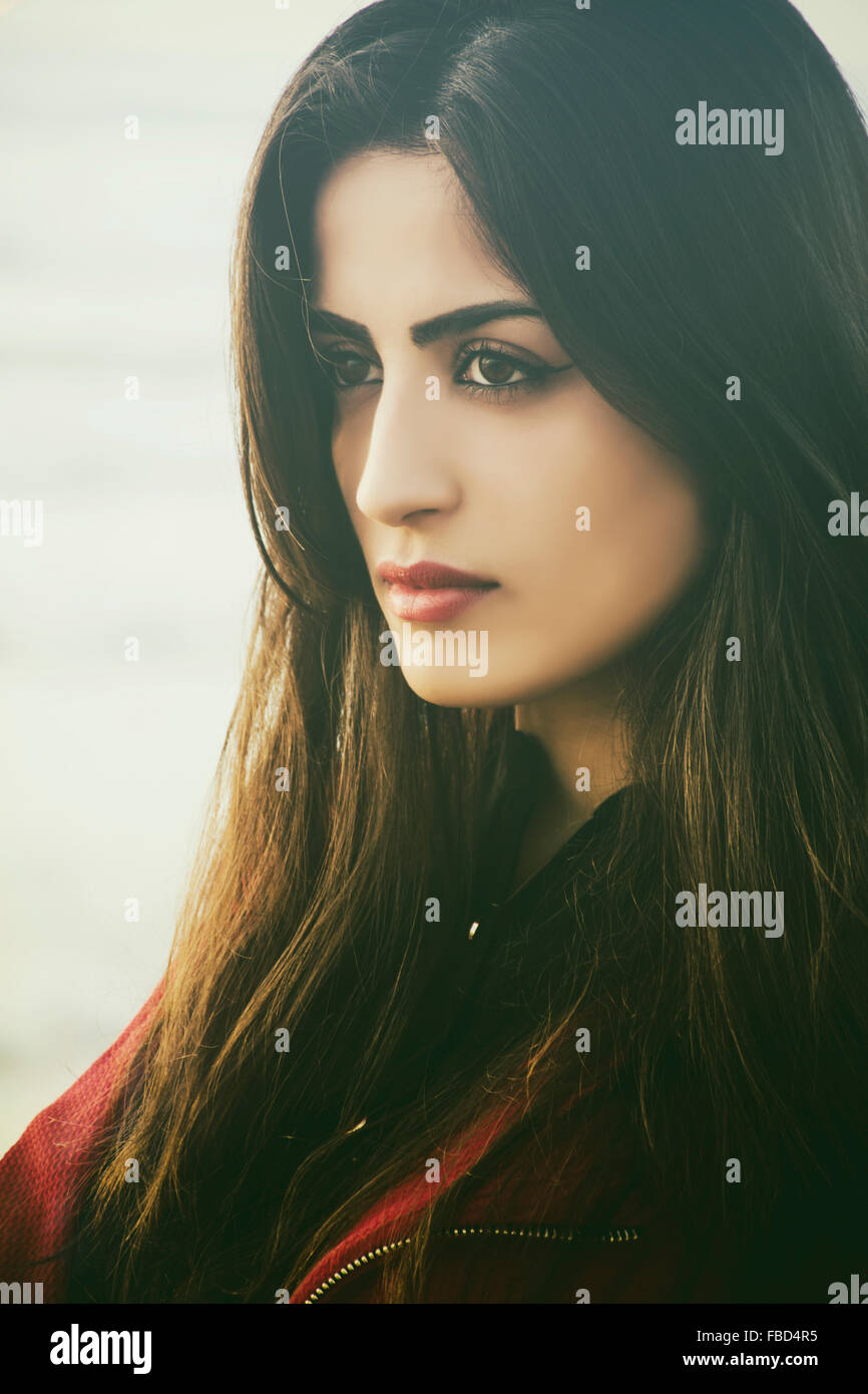 Beautiful young woman looking away outdoors Stock Photo - Alamy