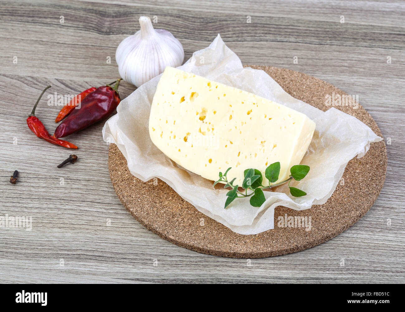 Part of round cheese on the wood background with herbs Stock Photo - Alamy