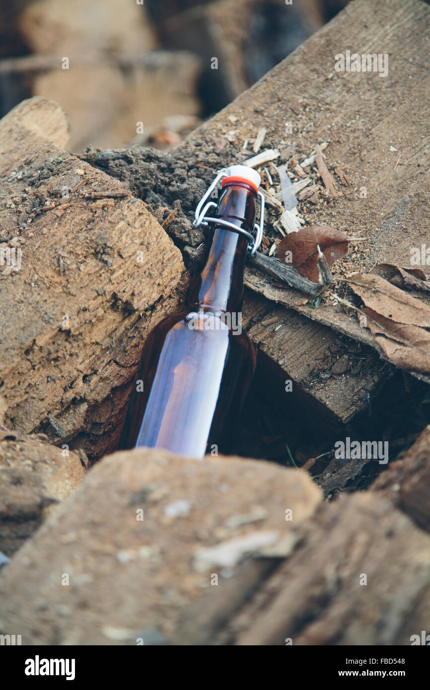 Glass bottle on wooden stack Stock Photo - Alamy