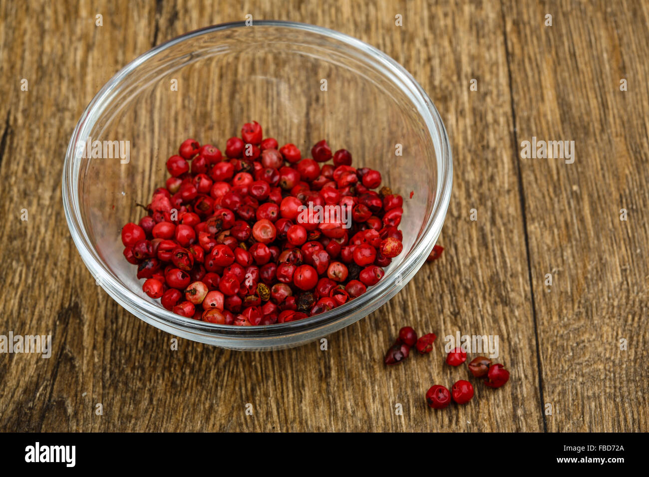 Dry Rose pepper corn on the wood background Stock Photo - Alamy