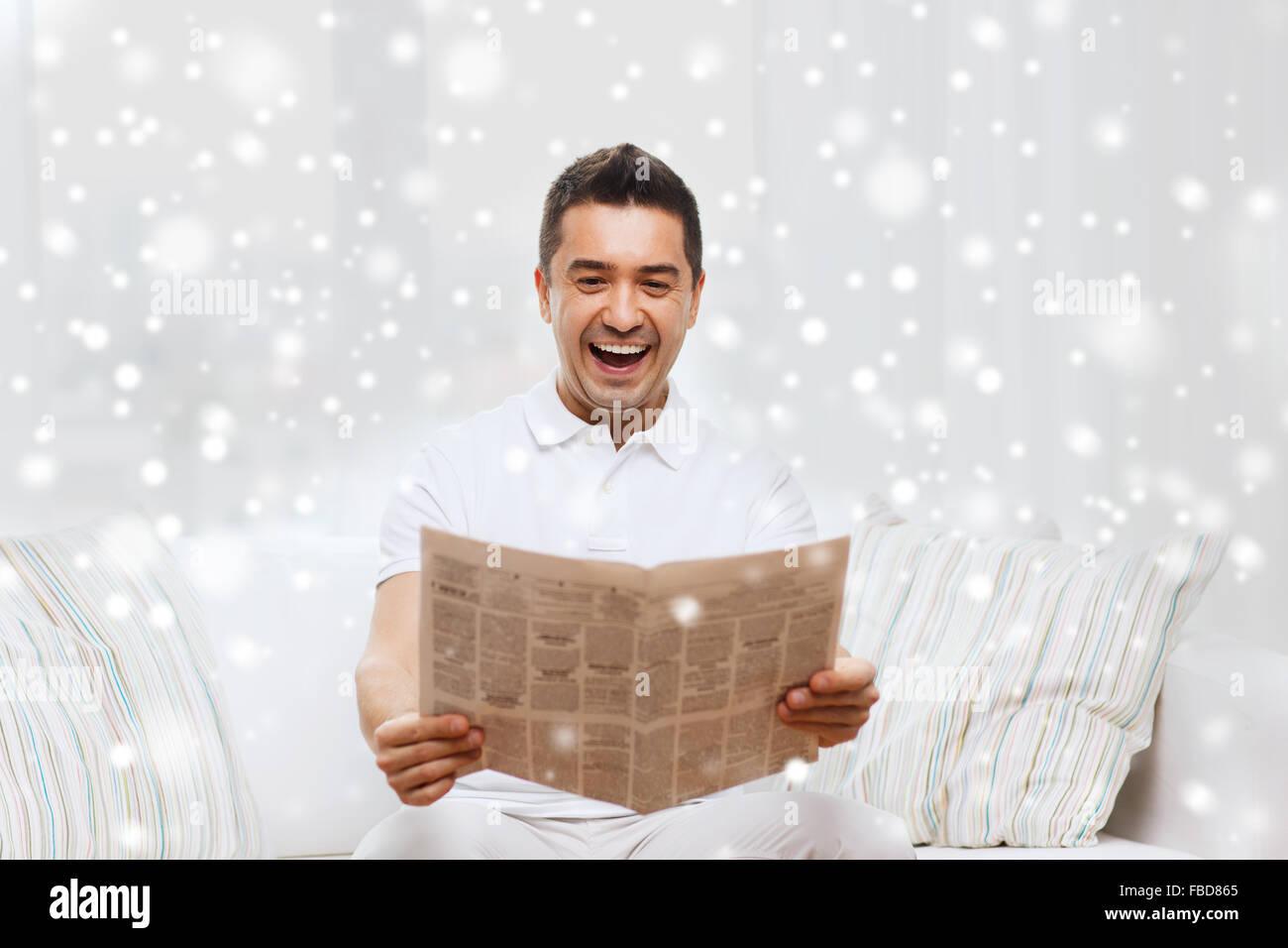 happy man reading newspaper and laughing at home Stock Photo - Alamy