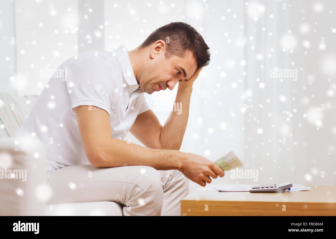 man with money and calculator at home Stock Photo - Alamy