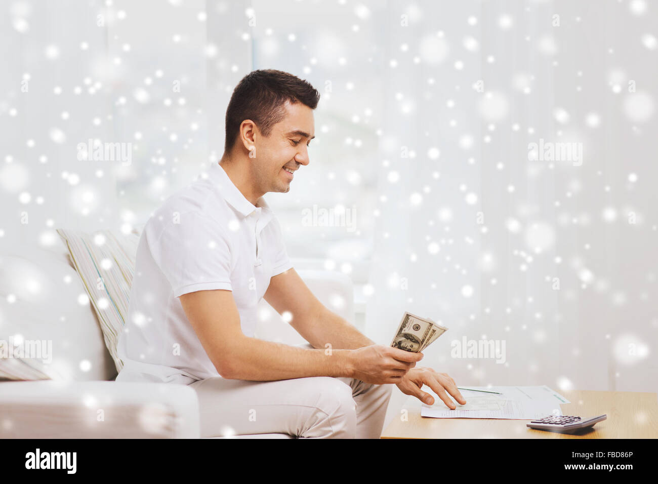 man with papers and calculator counting money Stock Photo - Alamy