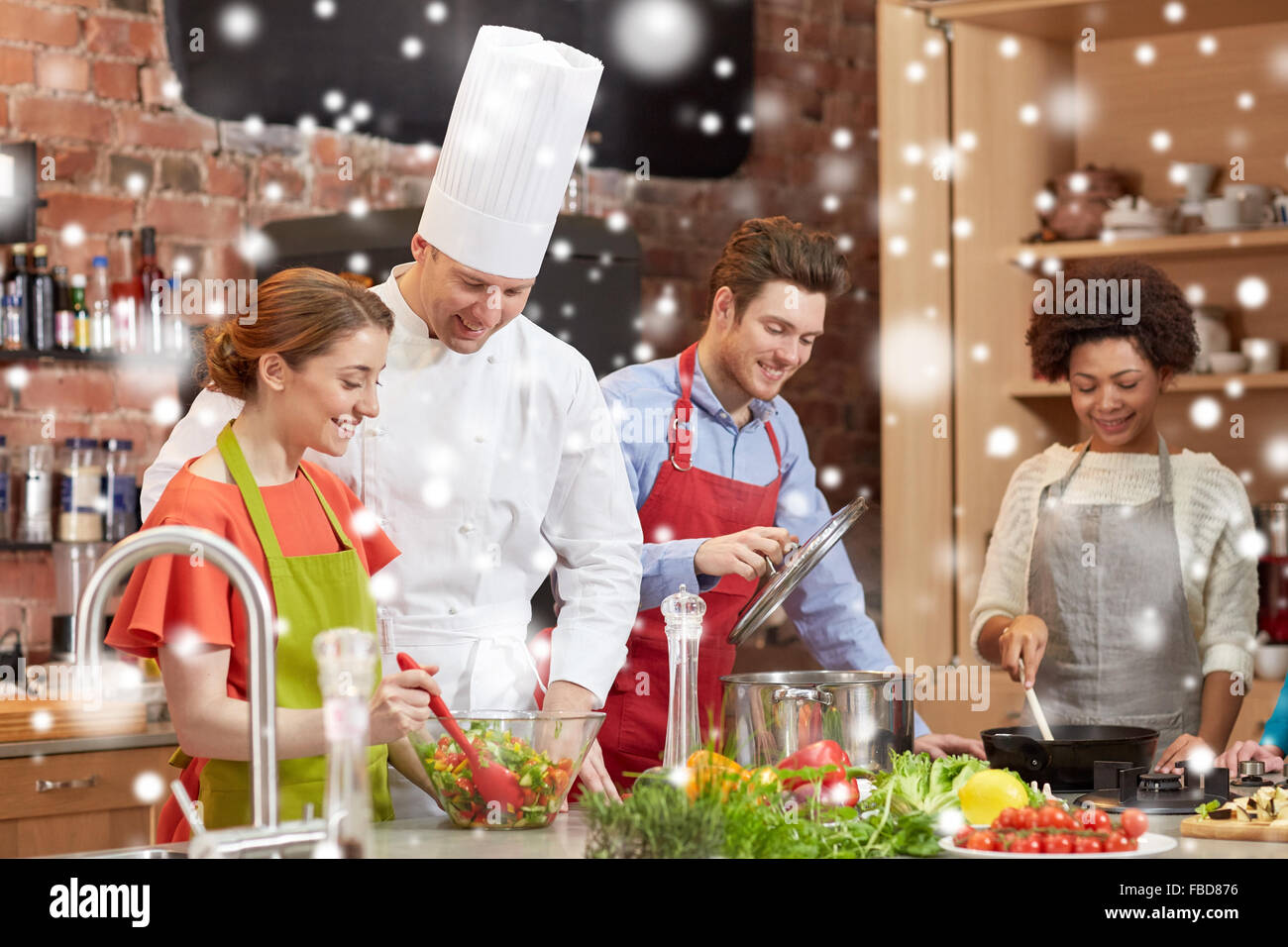 happy friends and chef cook cooking in kitchen Stock Photo - Alamy