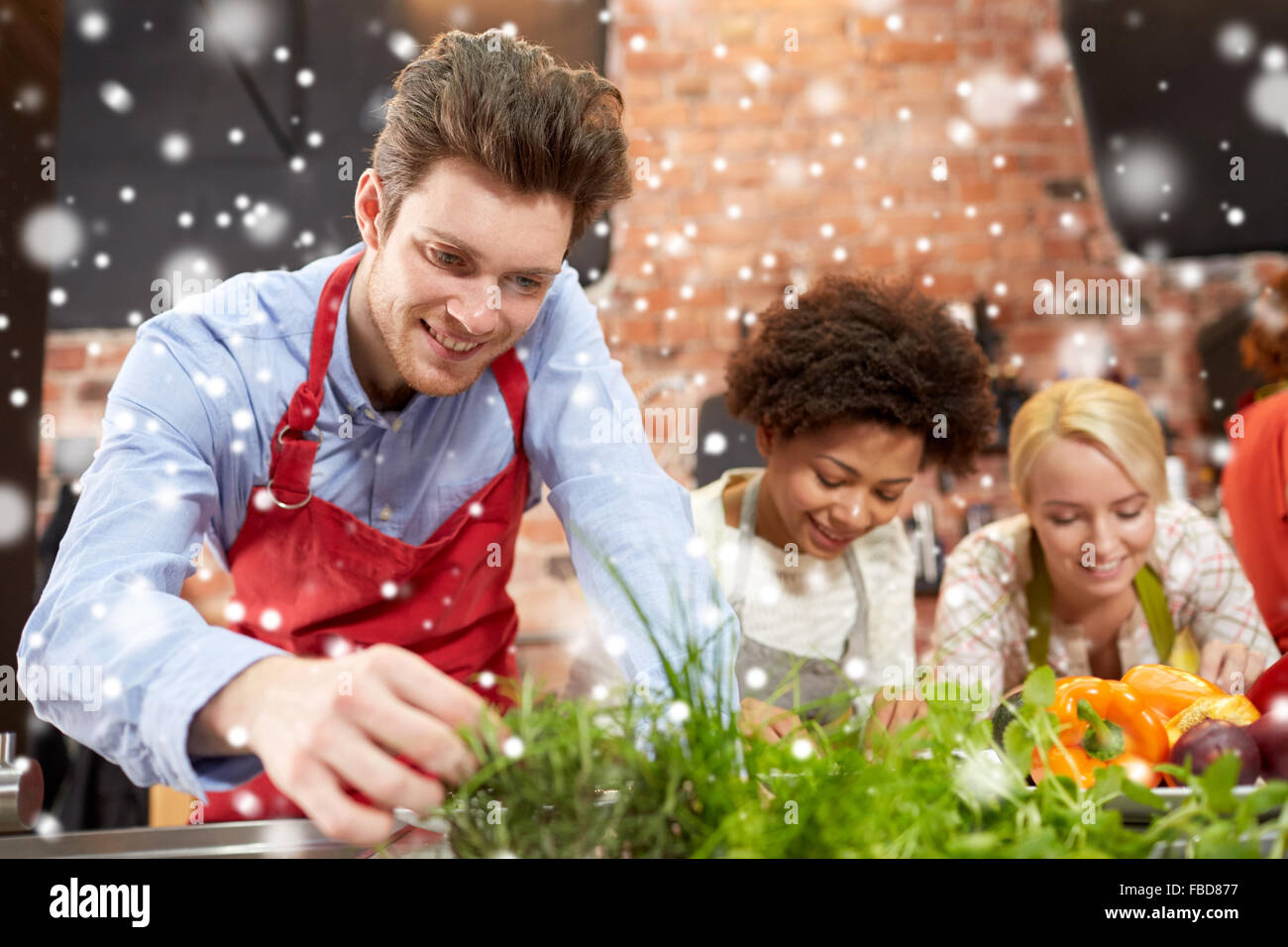 happy friends cooking and decorating dishes Stock Photo - Alamy