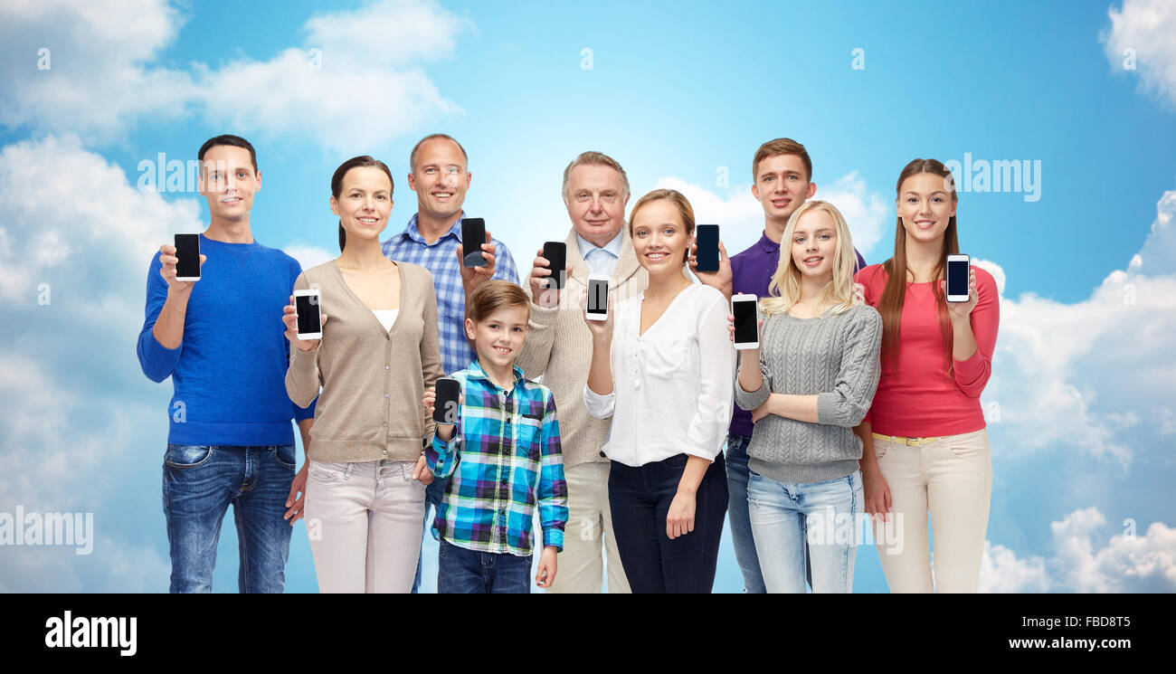 happy people with smartphones over sky and clouds Stock Photo - Alamy