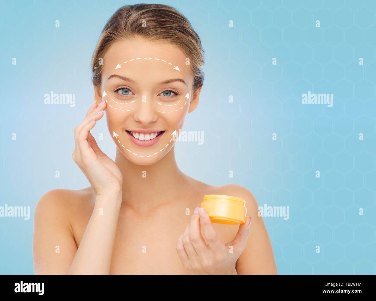 happy young woman applying cream to her face Stock Photo - Alamy