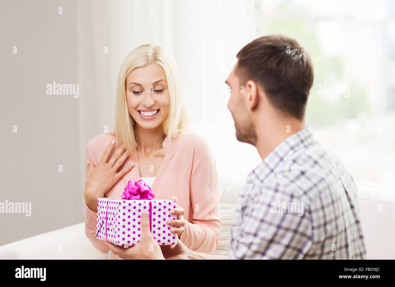 happy man giving woman gift box at home Stock Photo - Alamy