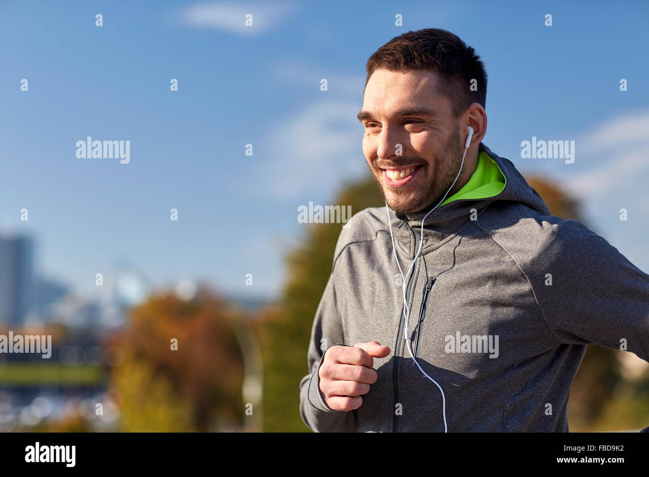 happy man with earphones running in city Stock Photo - Alamy