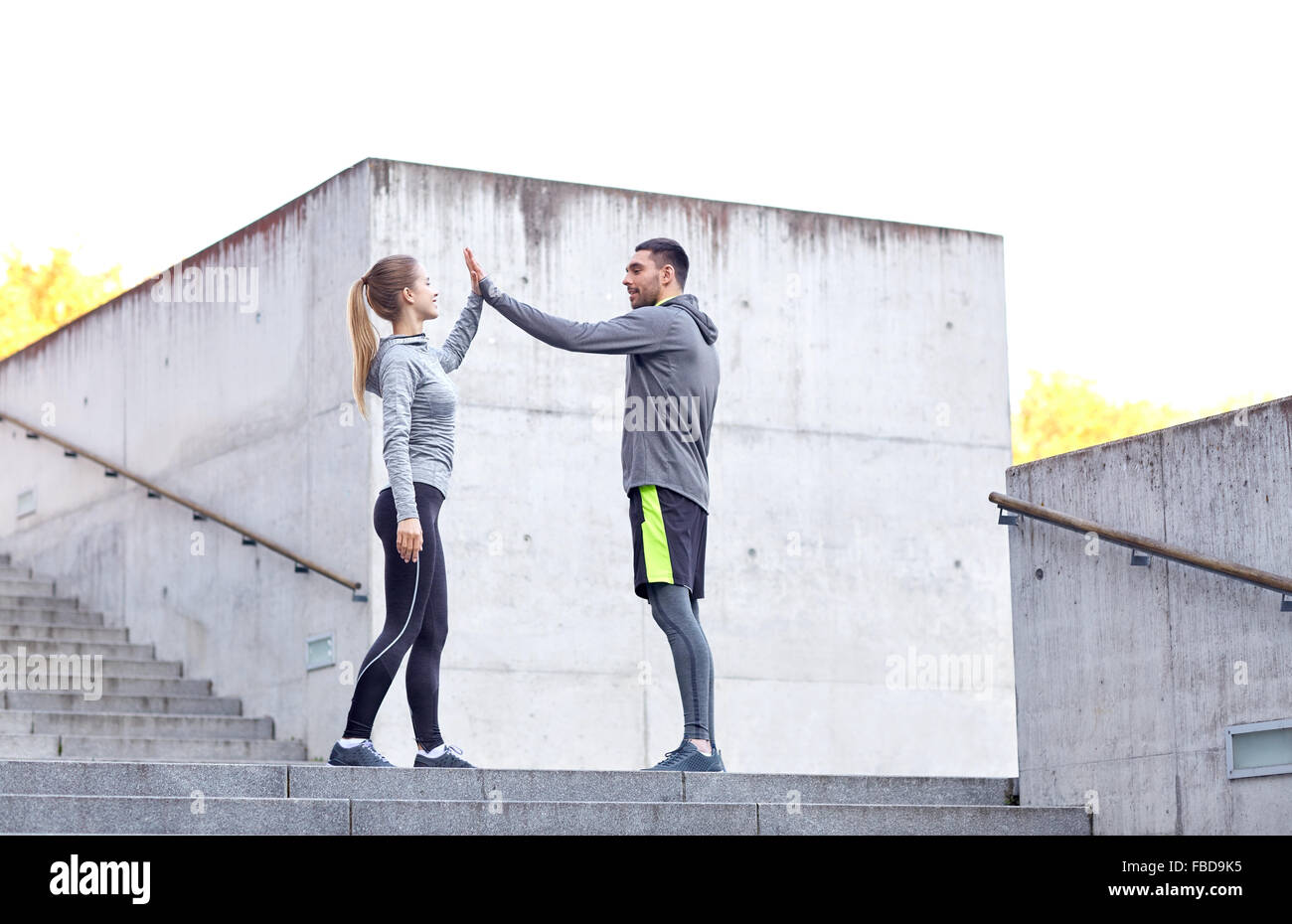 happy couple giving high five outdoors Stock Photo - Alamy
