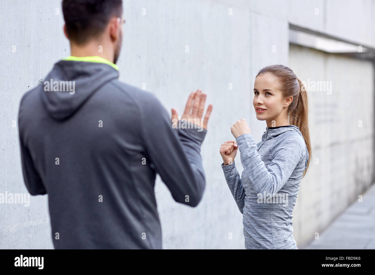 happy woman with coach working out strike outdoors Stock Photo - Alamy