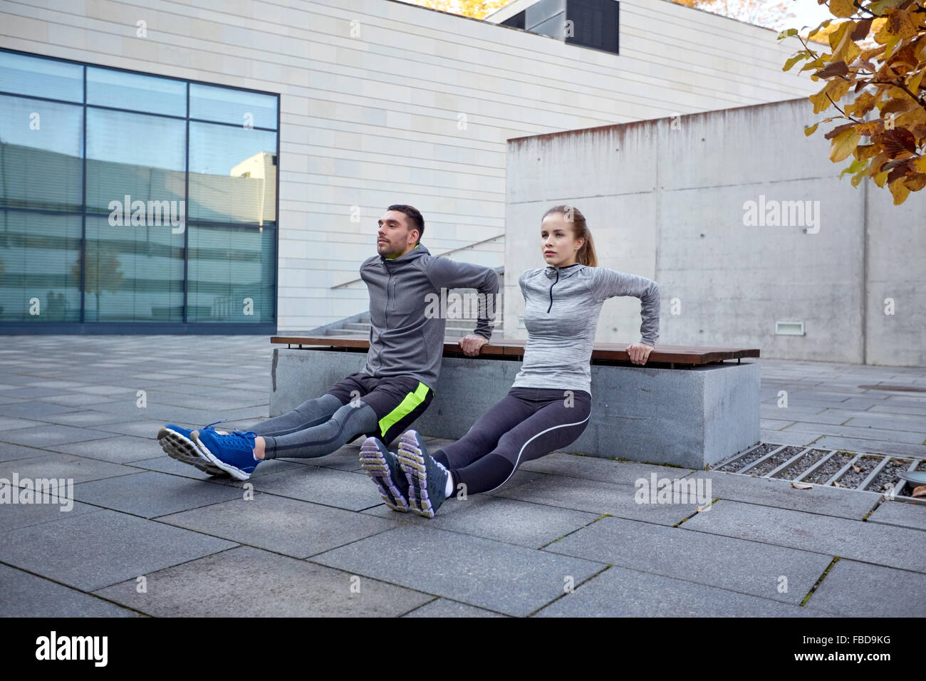 couple doing triceps dip exercise outdoors Stock Photo - Alamy