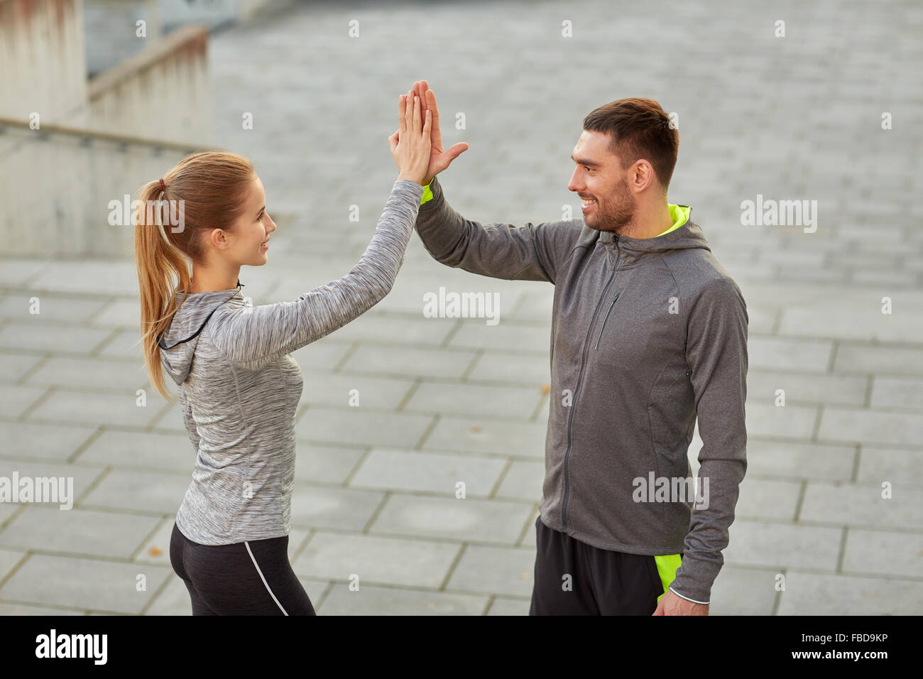happy couple giving high five outdoors Stock Photo - Alamy