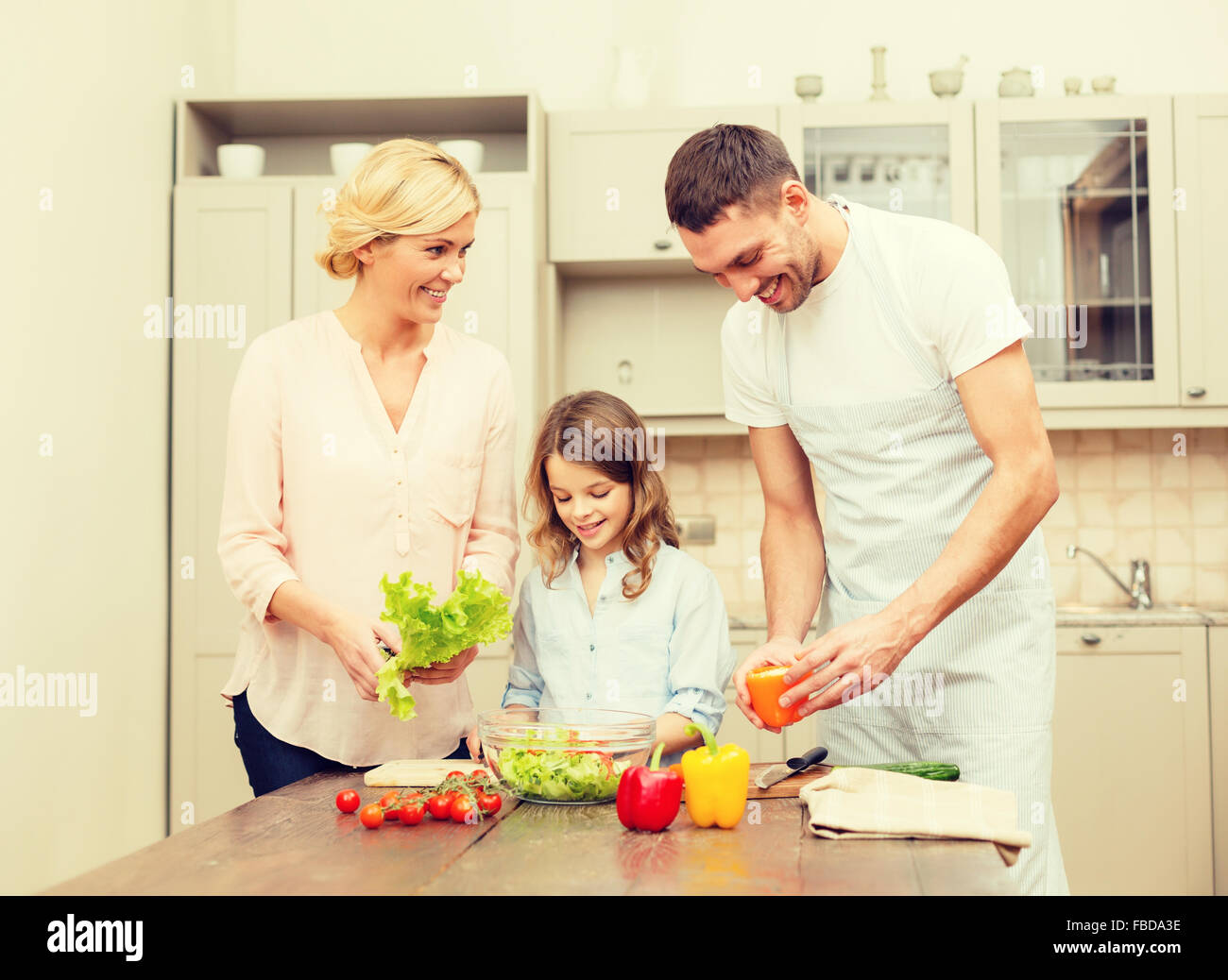 happy family making dinner in kitchen Stock Photo - Alamy