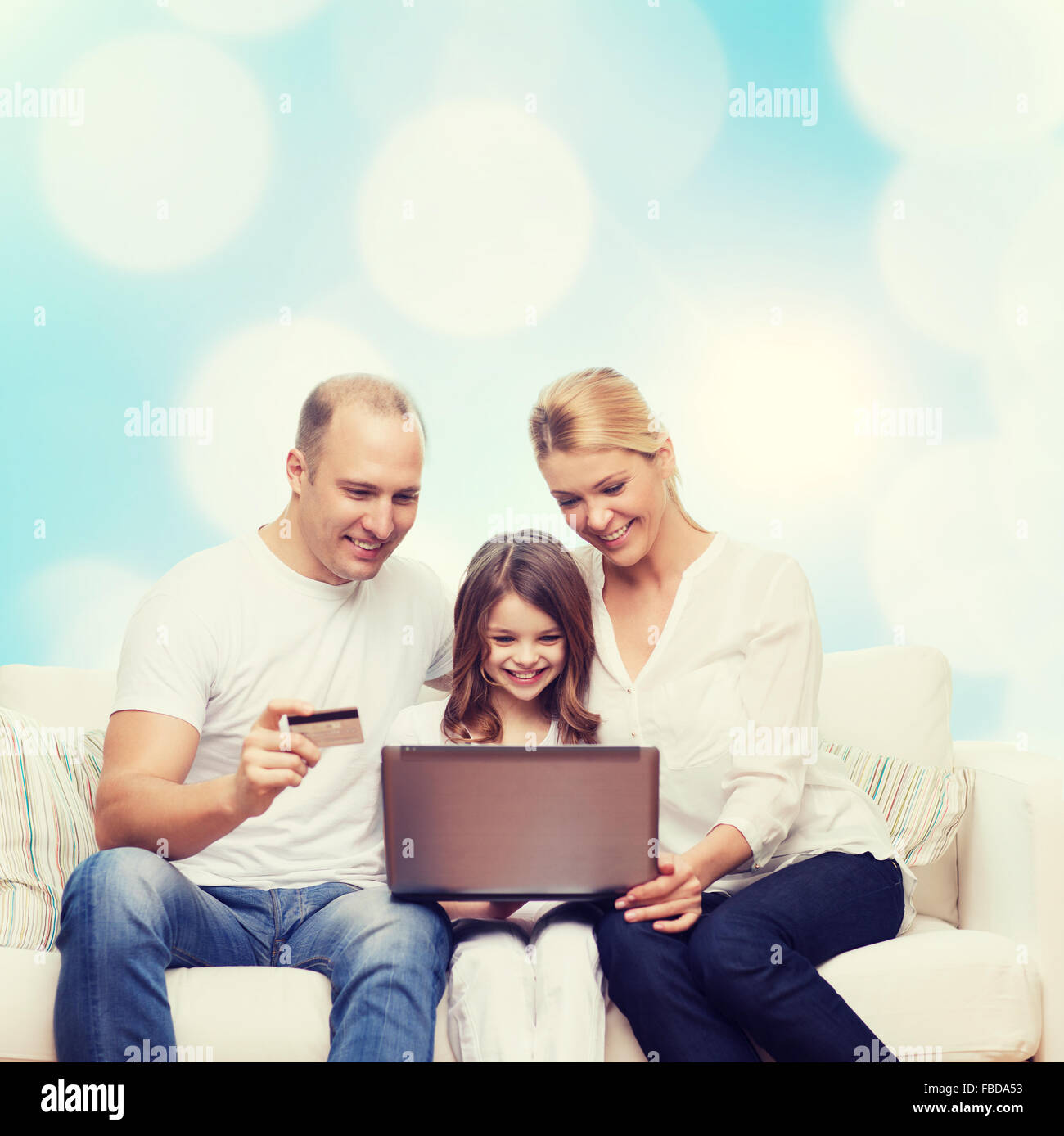 happy family with laptop computer and credit card Stock Photo - Alamy