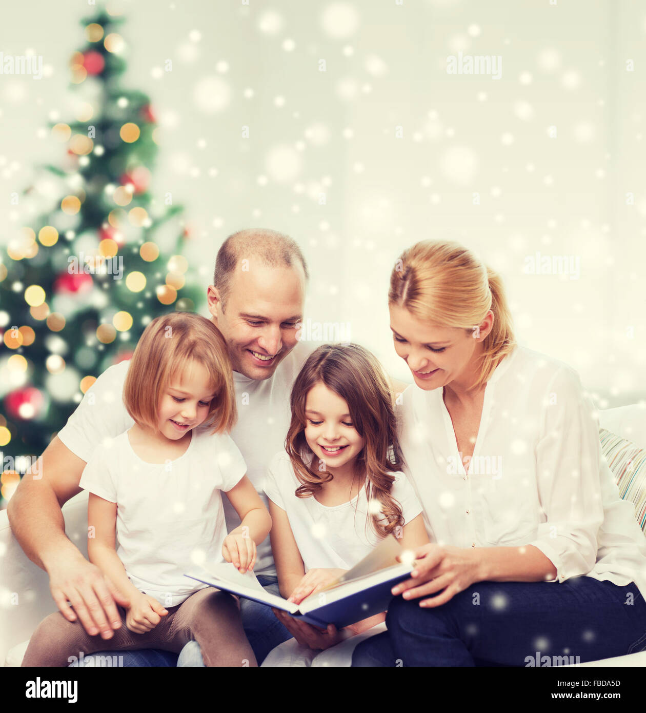 happy family with book at home Stock Photo - Alamy