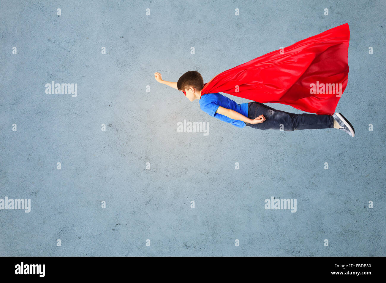 boy in red superhero cape and mask flying on air Stock Photo - Alamy