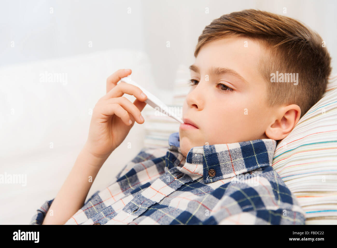 ill boy with flu and thermometer at home Stock Photo - Alamy