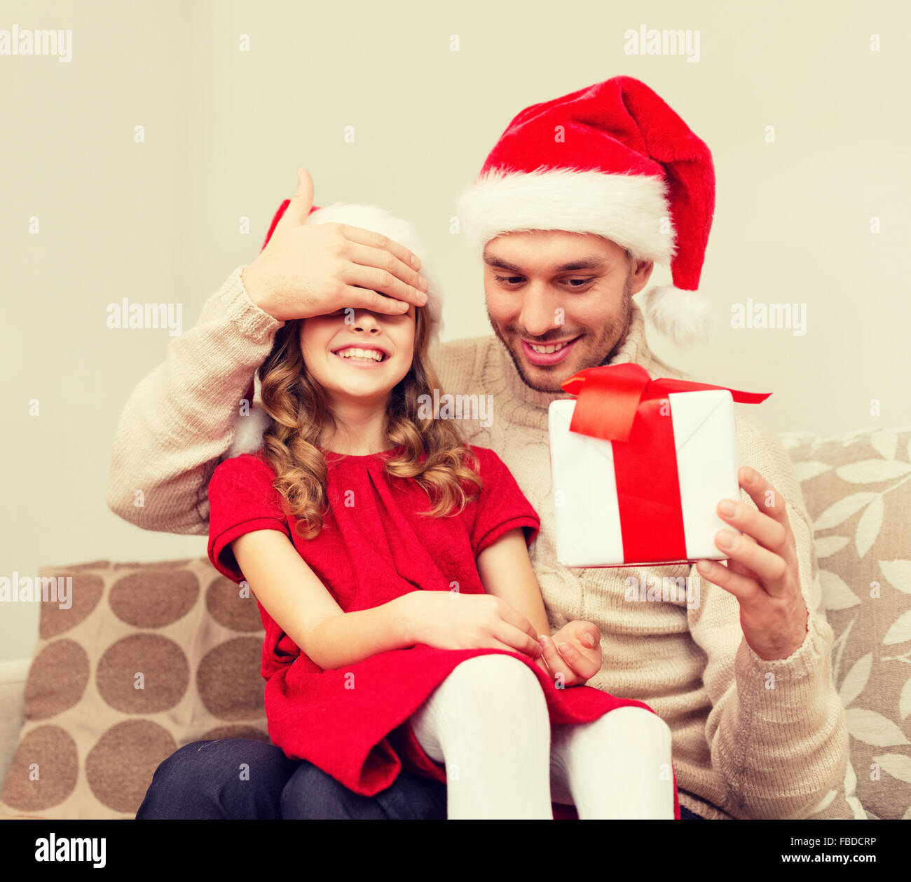 smiling father surprises daughter with gift box Stock Photo - Alamy