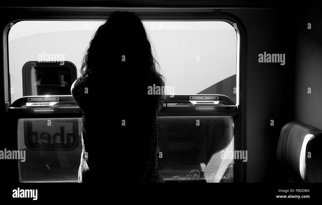 Rear View Of Woman Standing In Front Of Train Window Stock Photo - Alamy