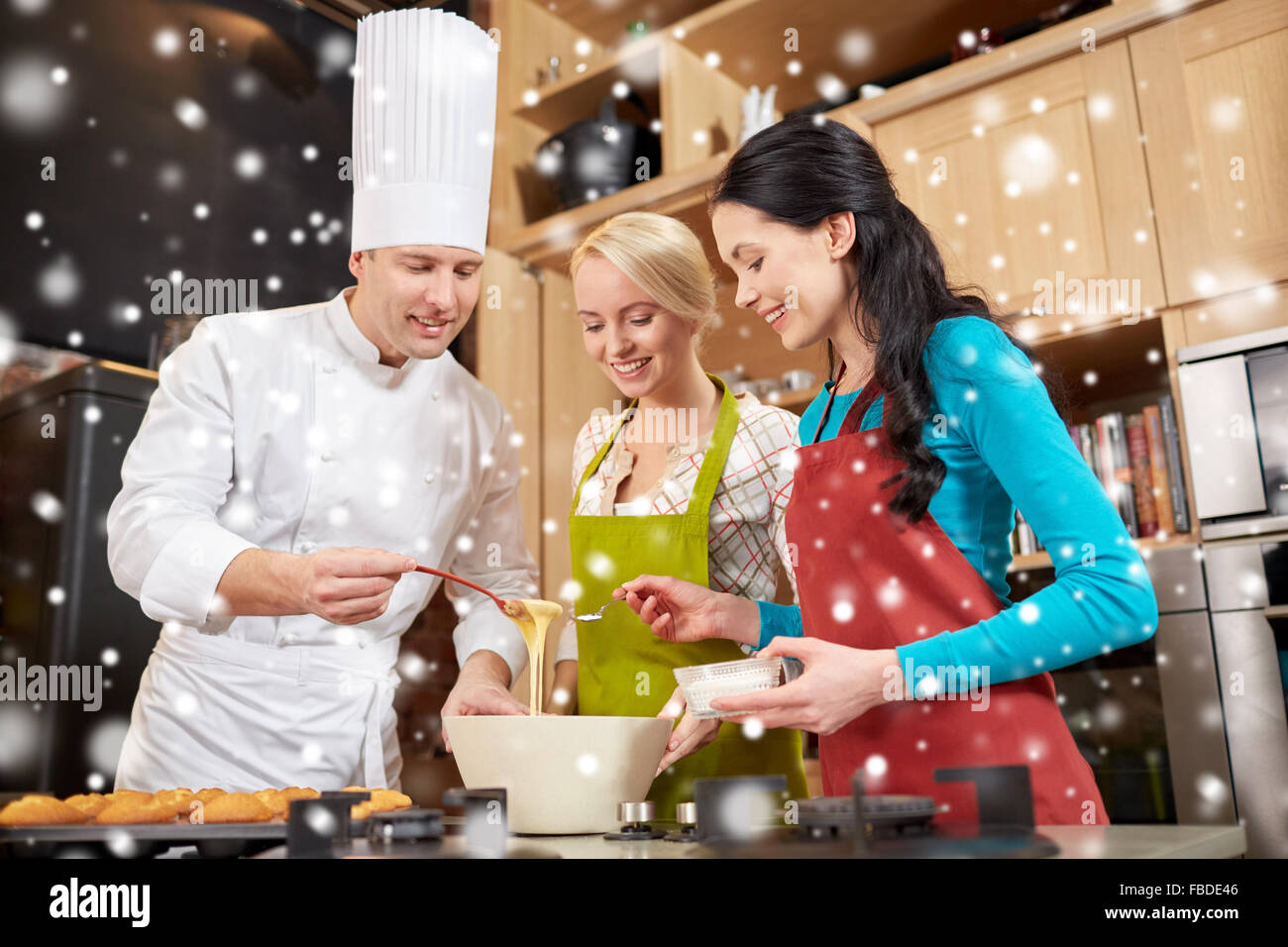 happy women and chef cook baking in kitchen Stock Photo - Alamy