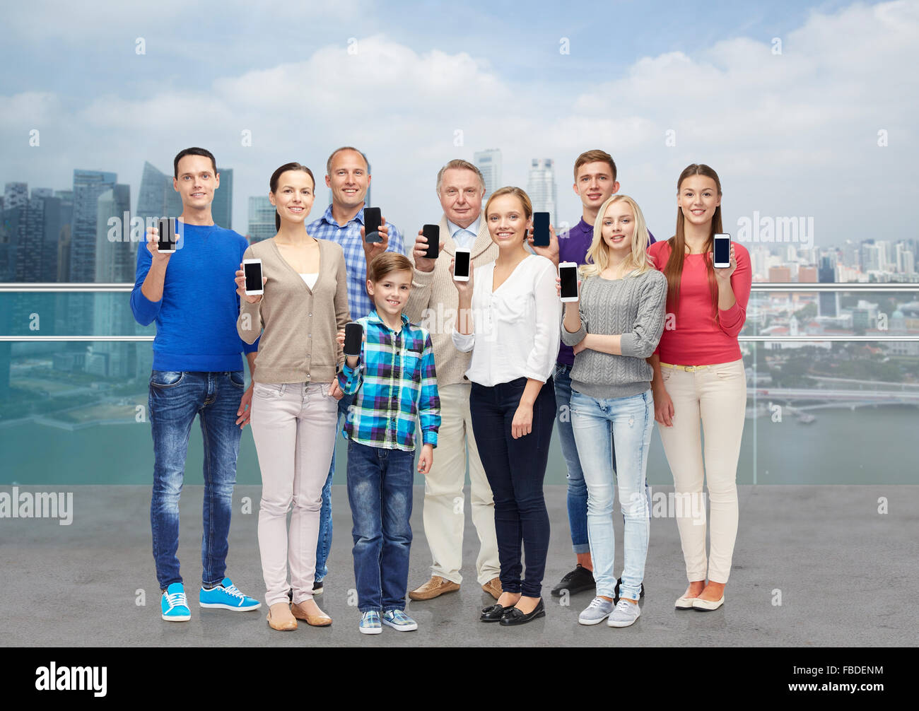 happy people with smartphones over city waterside Stock Photo - Alamy
