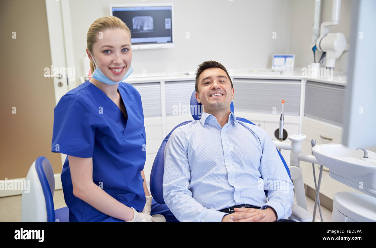 happy female dentist with man patient at clinic Stock Photo - Alamy