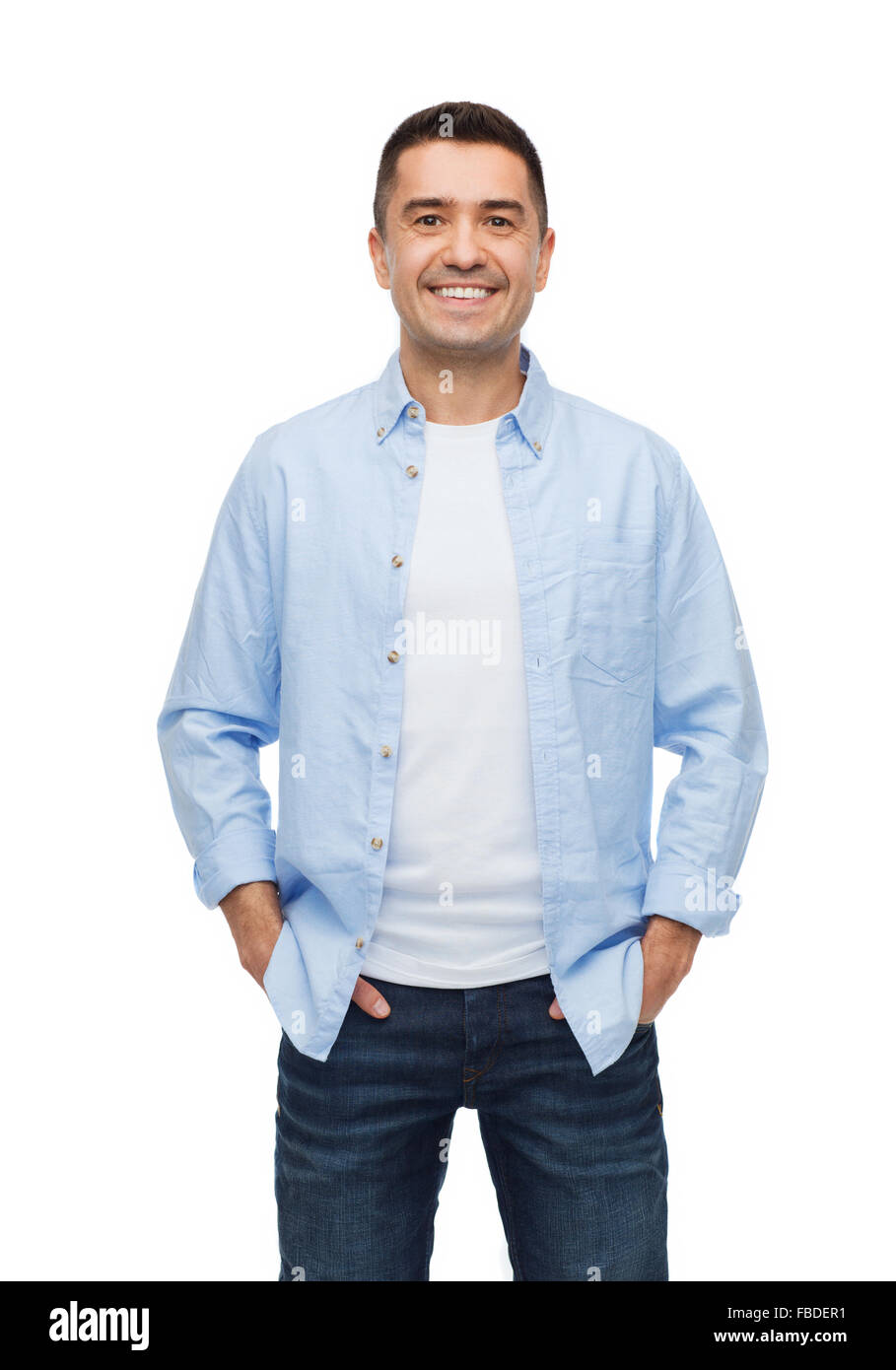 smiling man with hands in pockets Stock Photo - Alamy