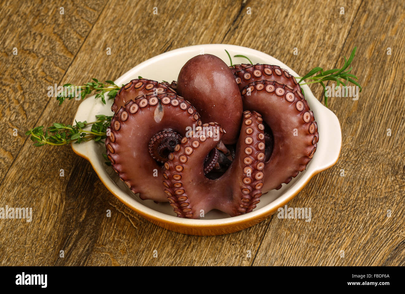 Boiled octopus with herb on the wood background Stock Photo - Alamy