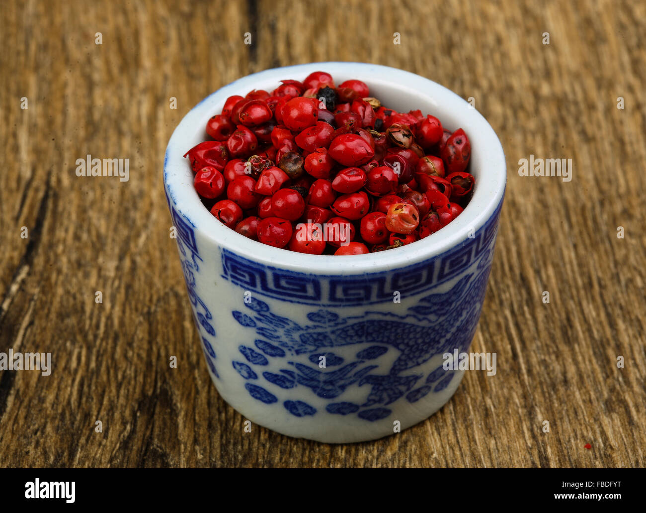 Dry Rose pepper corn on the wood background Stock Photo - Alamy