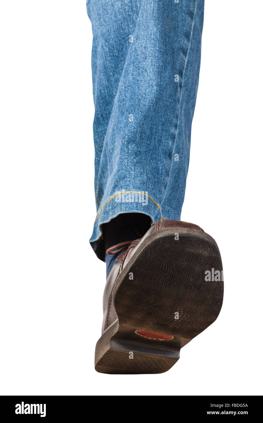 front view of male left leg in jeans and brown shoe takes a step ...