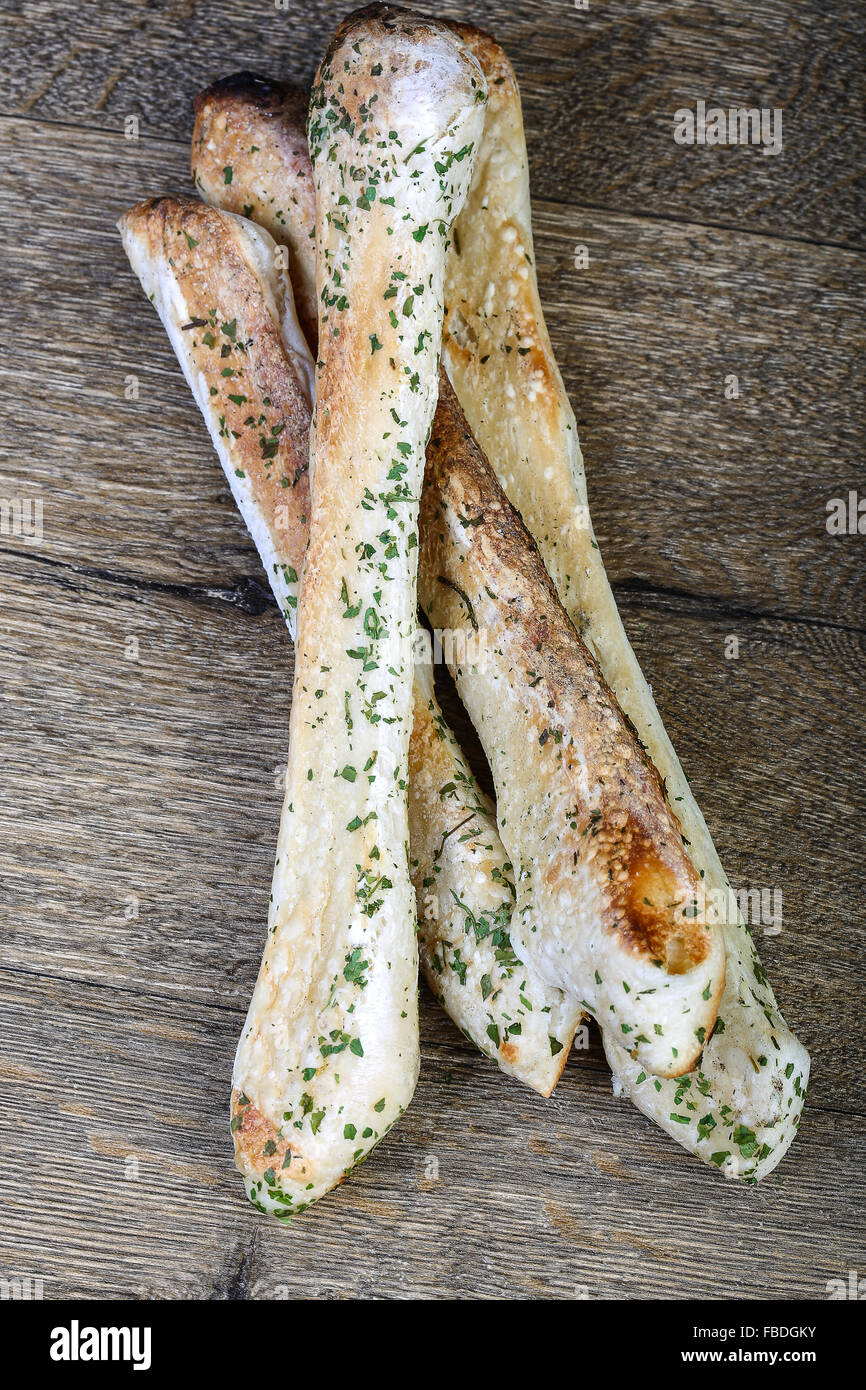 Italian bread stick with herbs on the wood background Stock Photo - Alamy