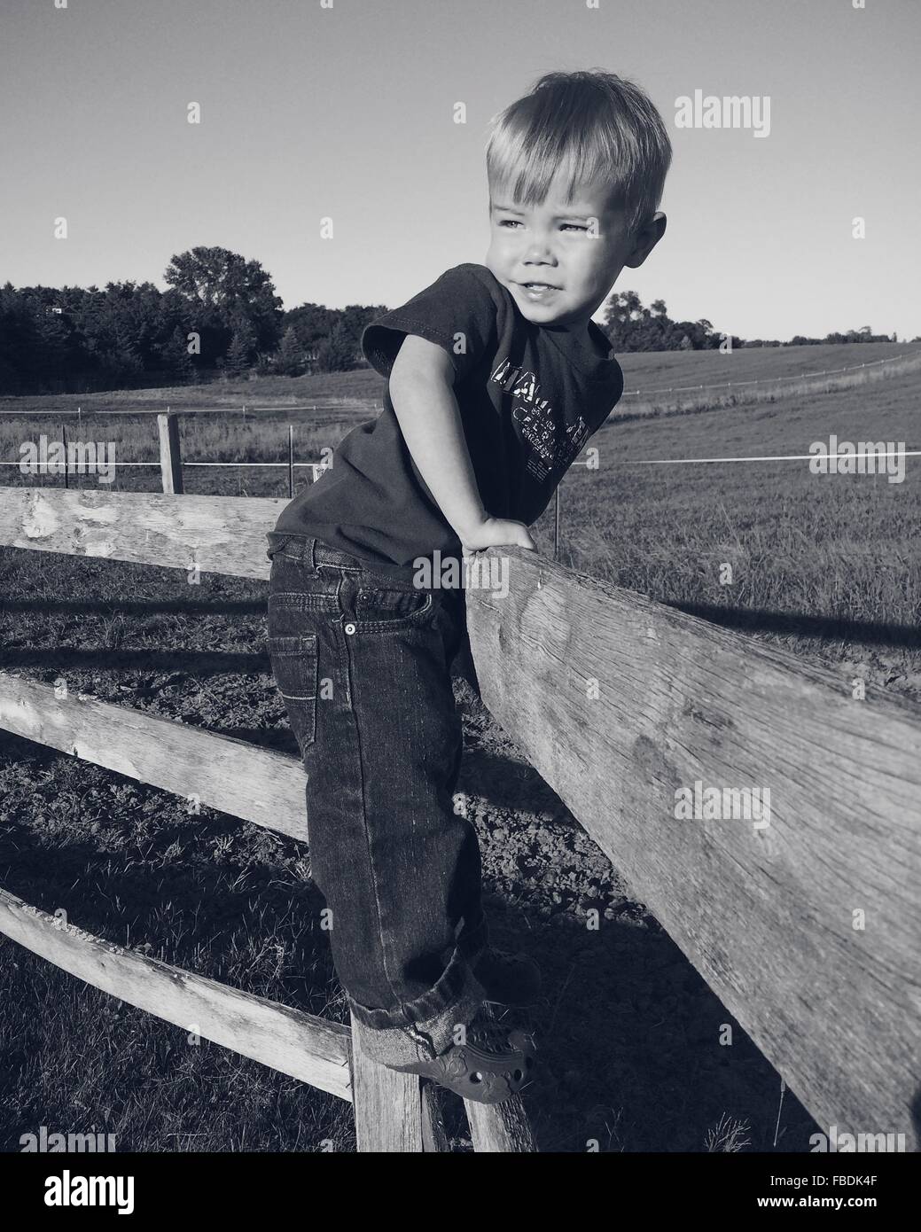Looking away standing holding protection safety fence hi-res stock ...