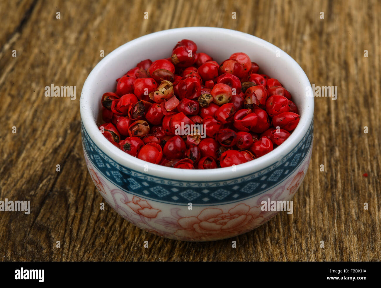 Dry Rose pepper corn on the wood background Stock Photo - Alamy