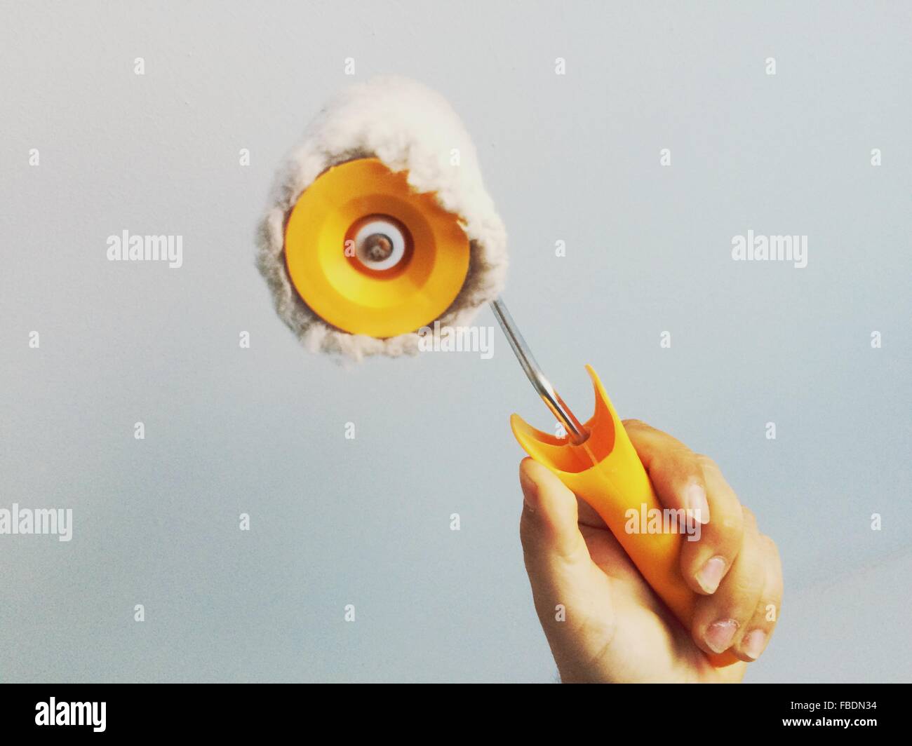 Cropped Hand Holding Paint Roller Against White Background Stock Photo ...