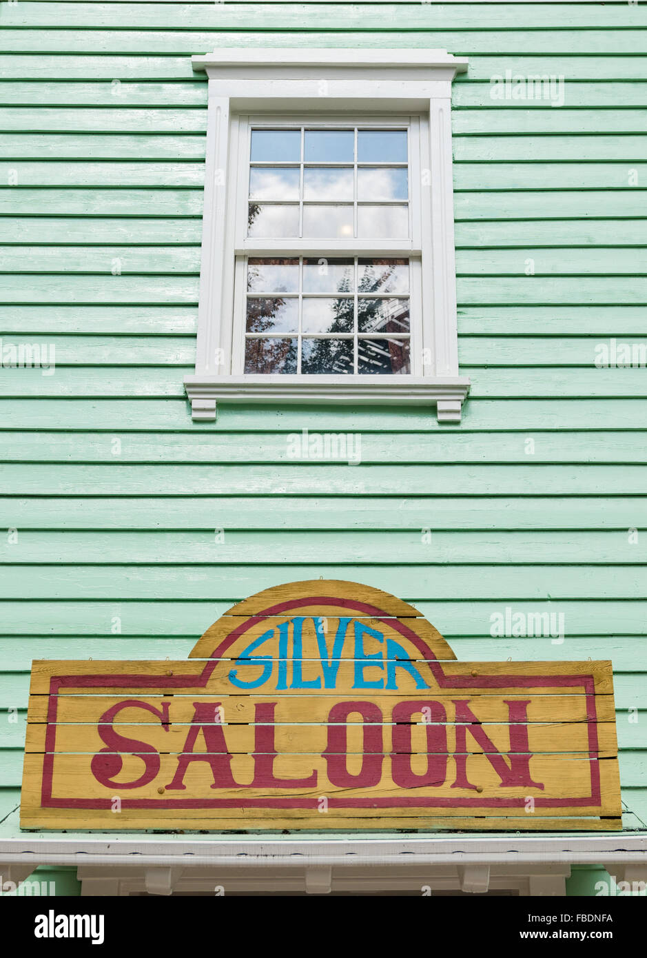 Detail of the facade of a saloon painted green with white windows Stock ...